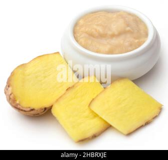 Ginger with paste over white background Stock Photo - Alamy