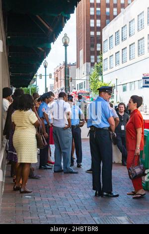extras or background actors dressed as a cop in period 1970s clothes ...