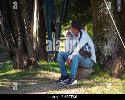 Young latin man tired using laptop sitting on bed at bedroom Stock ...
