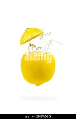 Summer refreshing drink. Levitation of lemon slices with a straw on ...