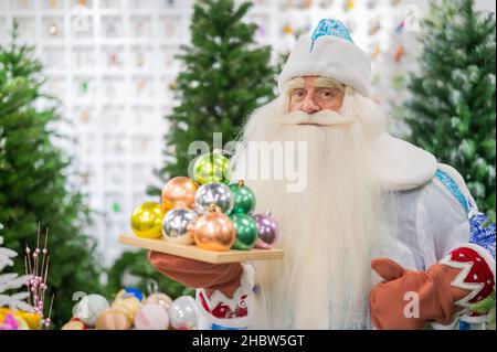 Russian santa claus holds decorations for the christmas tree in the ...