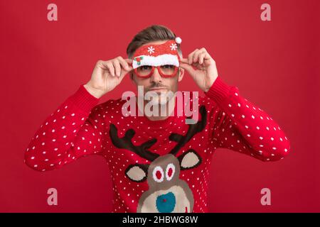 funny man in winter sweater and party antlers. xmas guy on red ...