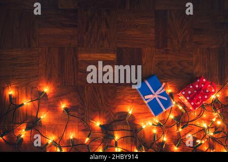 Christmas greeting card with gift box and fir tree branch over wooden ...