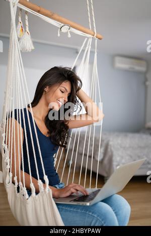 Beautiful student woman learning online on computer at home. Technology ...