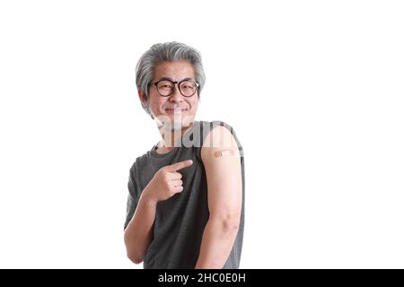 The senior Asian man showing plaster on his shoulder Stock Photo - Alamy