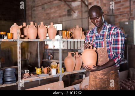 Potter checking clay products Stock Photo - Alamy