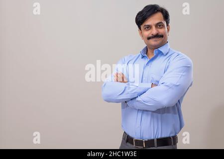 Man in formal dress posing in front of camera with folding hands Stock ...