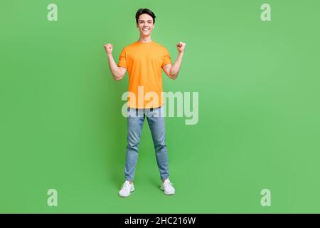 Photo of victorious young happy brunette woman raise fist win hold ...