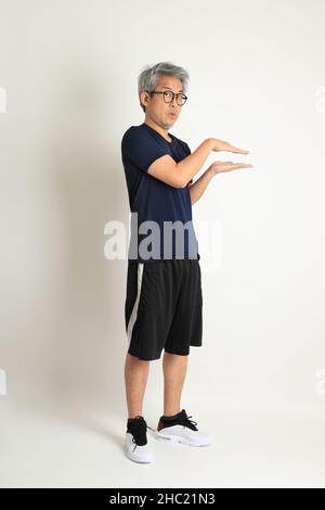 The Asian senior man with sport clothes on the white background Stock ...