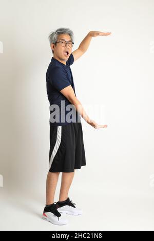 The Asian senior man with sport clothes on the white background Stock ...