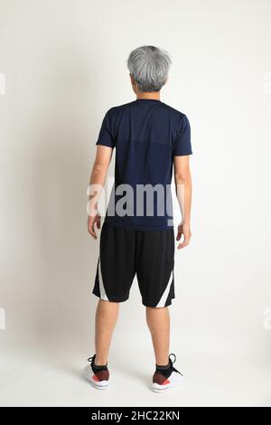 The Asian senior man with sport clothes on the white background Stock ...
