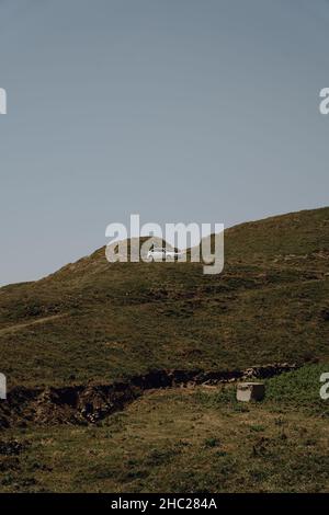 A stunning view of grassy hills under a blue cloudless sky in Tarifa ...