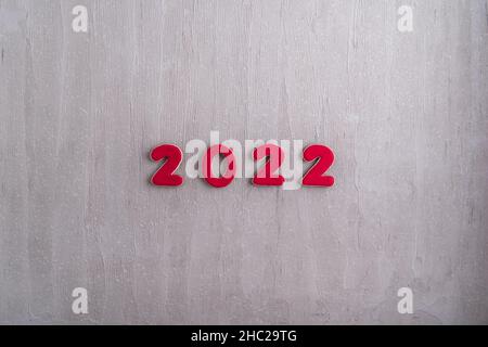 Inscription in red numbers 2022 from gingerbread on white background ...