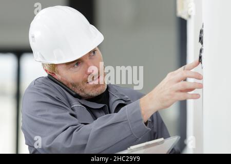 builders with tablet pc and equipment indoors Stock Photo - Alamy