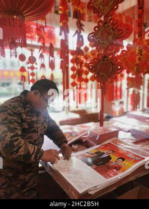 YANCHENG, CHINA - DECEMBER 23, 2021 - People buy New Year items at a ...