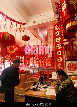 YANCHENG, CHINA - DECEMBER 23, 2021 - People buy New Year items at a ...