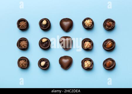 Different kinds of chocolates on colored table close-up. Top View and ...