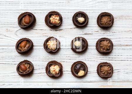 Different kinds of chocolates on colored table close-up. Top View and ...