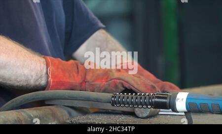 Ironworker forging hot iron in workshop Stock Photo - Alamy