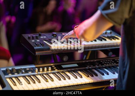 Close up of a keyboardist musician at work at a concert. Keyboardist ...