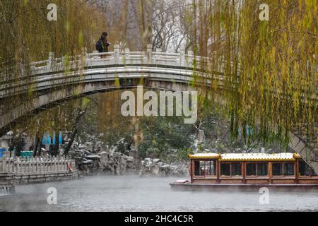 Jinan, China's Shandong Province. 24th Mar, 2017. Tourists walk under ...