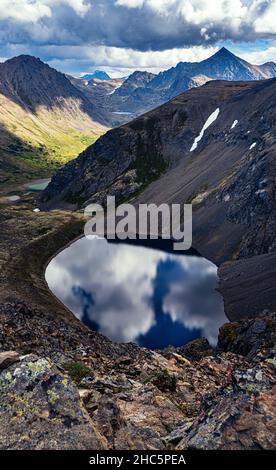 High angle shot of a beautiful lake below the green spruce trees Stock ...