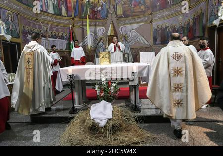 Palestinian priests seen at the alter during a midnight Mass on the Eve ...