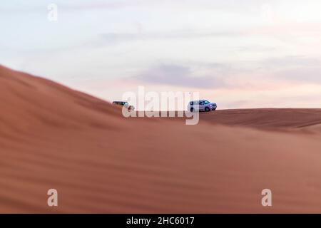 Shot of a SUV vehicle driving trough sand dunes Stock Photo - Alamy