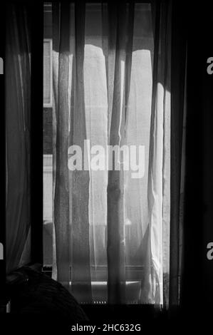 A grayscale vertical shot of a window on the old stone building Stock ...