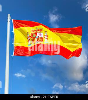 Spanish flag waving in wind with blue sky. Spain banner blowing, soft ...