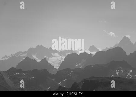 A beautiful shot of high mountain peaks with cloudy sky Stock Photo - Alamy