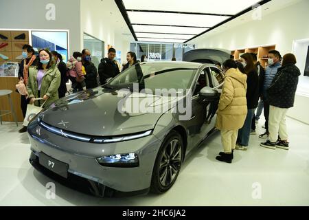 Customers experience new energy vehicles at a NIO showroom in Shanghai ...