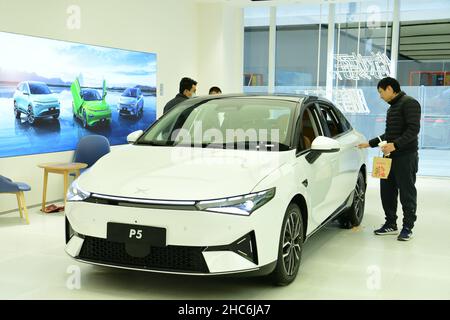 Customers experience new energy vehicles at a NIO showroom in Shanghai ...