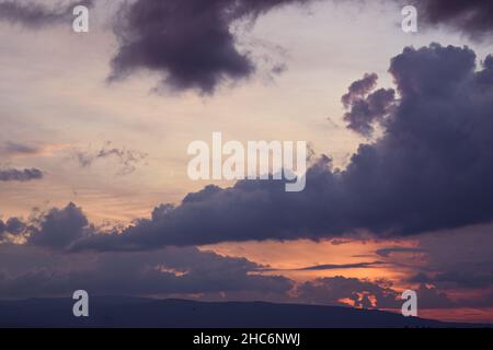 View of large billowing cloud in the background partly hidden by long ...