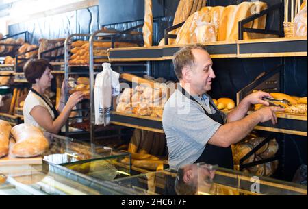 two bakers at the counter at bakery Stock Photo - Alamy