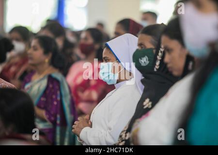Christian Devotees wearing masks attend prayers at a Holy Rosary ...