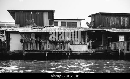 A grayscale shot of people in traditional Serbian clothes collecting ...