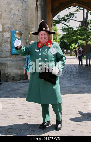 Male town crier & bellman (green gold crier's livery clothes) making ...