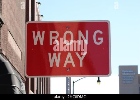 Closeup shot of a red "Wrong Way" sign on a blurred background Stock ...