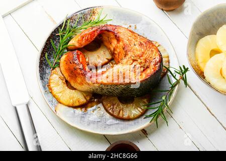 Fried trout fish steak with pineapple. Roasted salmon steak. Copy space ...