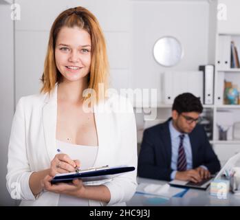 Secretary writing boss instructions Stock Photo - Alamy