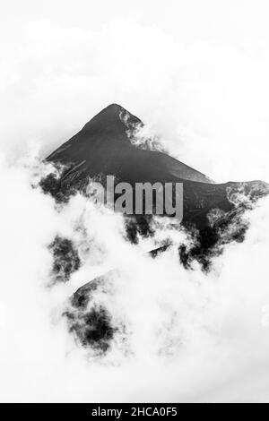 Grayscale shot of the Fuego volcano in Guatemala during eruption with ...