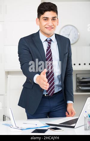 Young male manager is going to meet first visitors in his office Stock ...