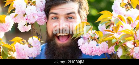 Spring banner of man outdoor. Outdoor partrait of young man surrounded ...