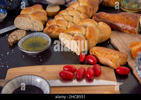 Feast, messy table. Bread in the shape of a braid. Sweet Challah ...