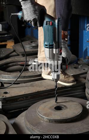 hammer drill pierces steel cylinders Stock Photo - Alamy