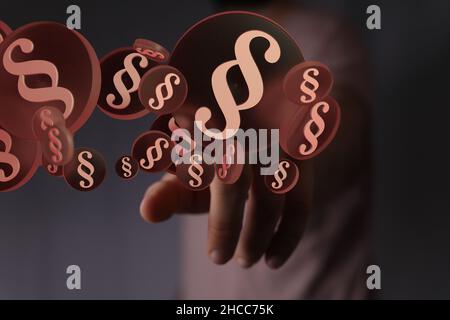 Closeup of the hand touching the floating justice and law icons. The ...