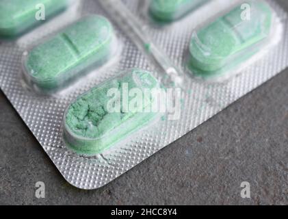 Crushed and damaged tablets in closeup view. Concept of expired drugs ...