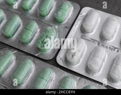 Crushed and damaged tablets in closeup view. Concept of expired drugs ...