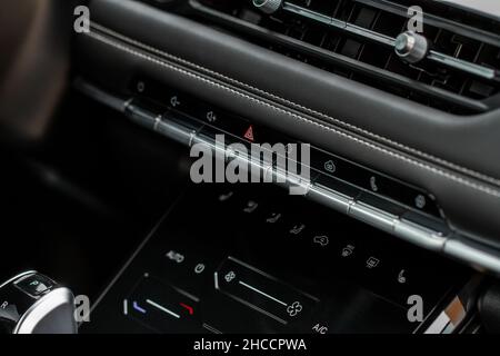 Red triangle hazard light button on car dashboard. Car media buttons ...